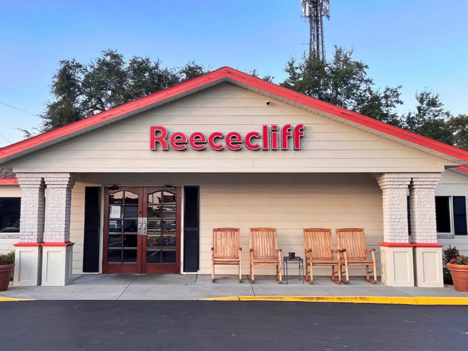 The iconic red-trimmed facade of Reececliff welcomes hungry travelers like a beacon of breakfast hope in Lakeland's morning landscape.