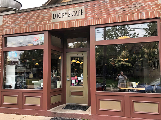 Lucky's Café welcomes hungry patrons with its charming brick exterior and warm burgundy trim—like a culinary lighthouse beckoning food lovers to safe harbor.