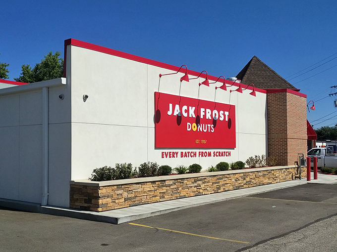 The white building with that bold red sign promises something magical inside. Like a donut beacon calling you home.