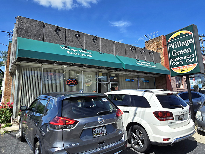 The unassuming exterior of Village Green Restaurant proves that culinary treasures often hide behind modest facades. Like finding Sinatra singing at your local VFW hall.