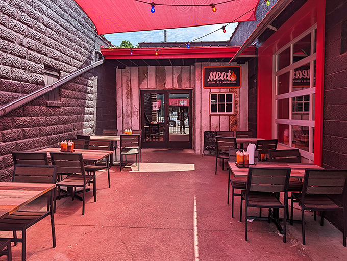 Outdoor dining nirvana awaits under a canopy of red with simple wooden tables &ndash; because fancy furniture would just distract from the main event: the meat.