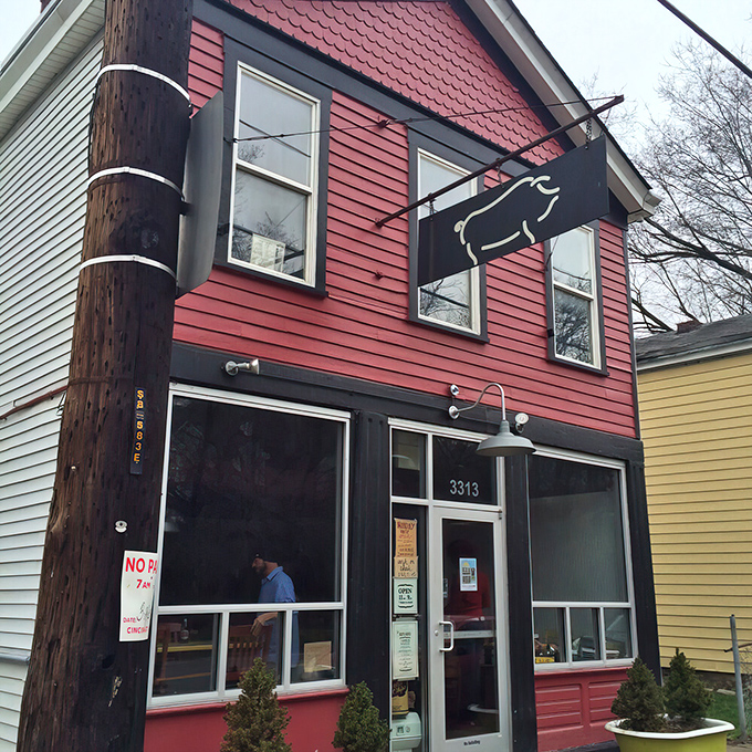 The unassuming pink exterior of Eli's BBQ might fool you, but that pig silhouette sign is basically a smoke signal saying "food paradise ahead."
