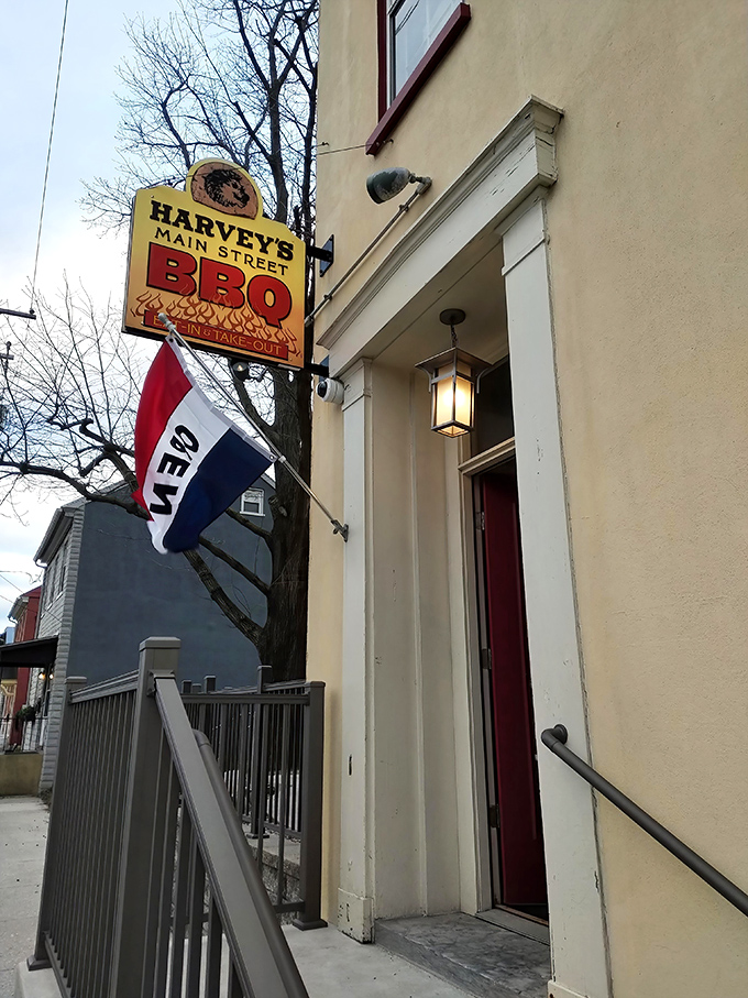 The unassuming entrance to Harvey's Main Street BBQ beckons with its vintage sign and "Open" flag &ndash; like a secret handshake for barbecue aficionados.