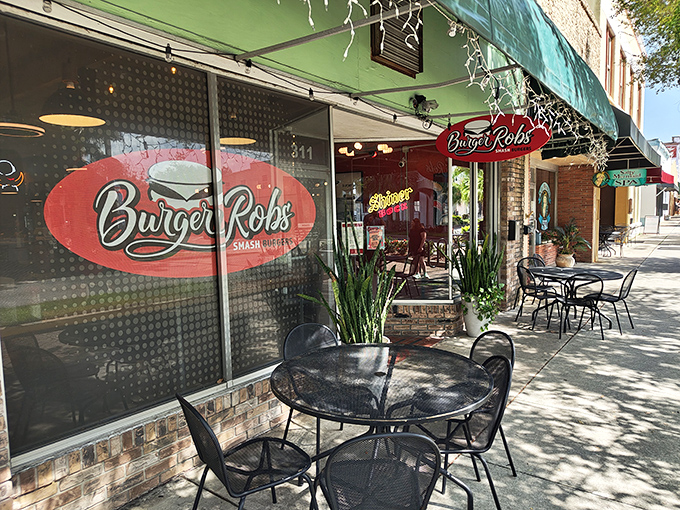 The green awning and bold red signage of BurgerRobs stands as a beacon for burger enthusiasts in downtown Titusville, promising smashed perfection within.