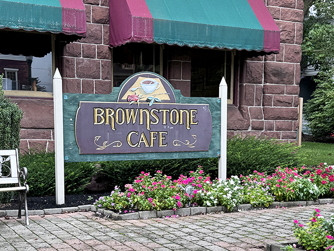 The iconic brownstone exterior with its distinctive green and burgundy awnings invites you in like an old friend waiting with open arms.