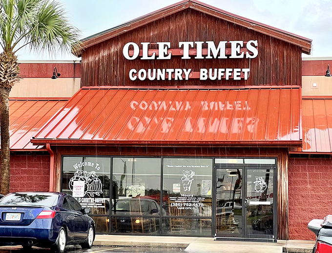 The rustic barn-like exterior of Ole Times Country Buffet promises what every road trip needs&mdash;comfort food that doesn't apologize for being exactly what it is.