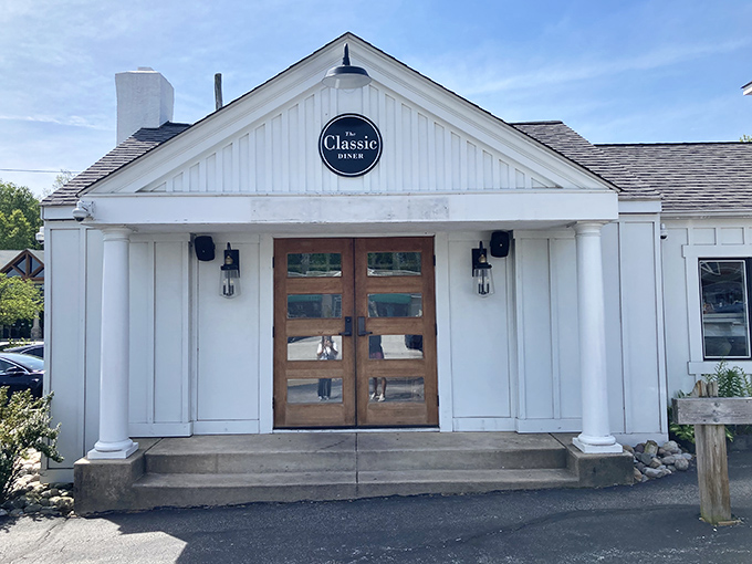 The white clapboard exterior with those welcoming wooden doors isn't trying to be fancy&mdash;it's promising something better: breakfast perfection waiting inside.
