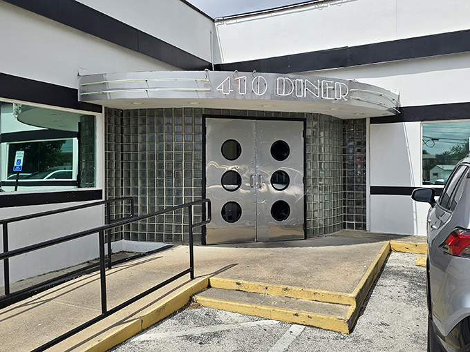 The iconic porthole doors of 410 Diner beckon like a time machine to the golden age of American roadside dining.