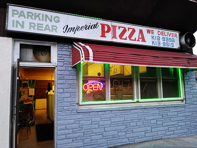 The blue brick facade of Imperial Pizza stands as a no-frills testament to pizza perfection in Secane. That neon "OPEN" sign might as well say "Pizza Paradise."