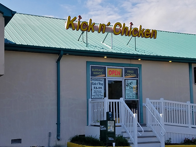 The cheerful yellow signage of Kick n' Chicken stands as a beacon of fried poultry perfection in Lewes, Delaware.