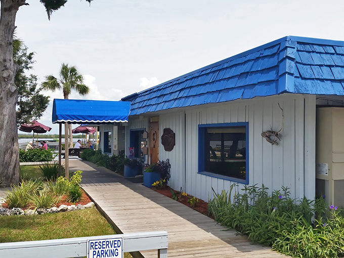 The wooden boardwalk leading to Peck's Old Port Cove feels like the entrance to a secret seafood society. Blue roof, white walls, and Florida sunshine&mdash;perfection awaits.