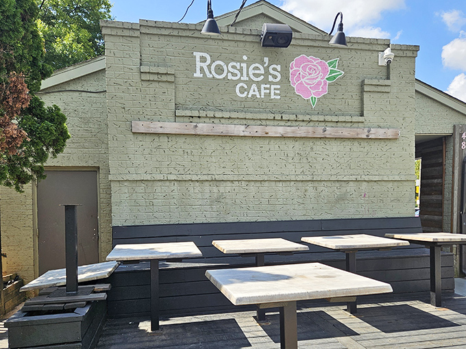 The unassuming exterior of Rosie's Cafe proves once again that culinary treasures often hide behind modest facades. That rose logo promises delicious things await inside.