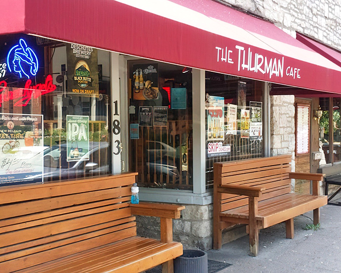 The unassuming storefront of Thurman Cafe, where culinary legends are born behind that modest red awning and wooden benches.