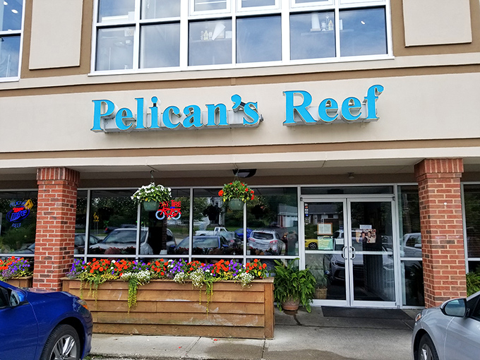 The bright blue sign of Pelican's Reef stands out like a maritime beacon, promising seafood salvation in suburban Cincinnati's unexpected strip mall setting.
