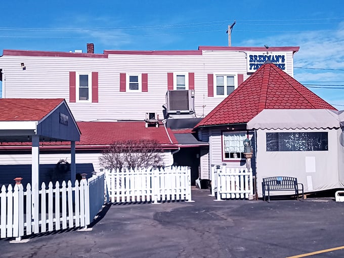 The iconic turret and weathered white siding of Brennan's Fish House stand as a beacon to seafood lovers, complete with a fish weathervane that seems to say "follow me to flavor!"