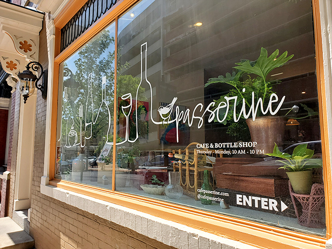 The elegant storefront window announces Passerine's dual identity as both caf&eacute; and bottle shop with artful simplicity.