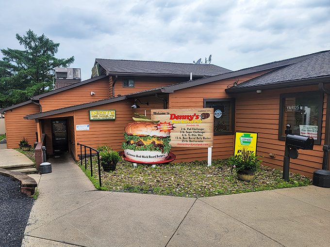 The legendary burger monument outside Denny's Beer Barrel Pub announces your arrival to burger paradise. This isn't just signage&mdash;it's a warning of the delicious challenges that await inside.