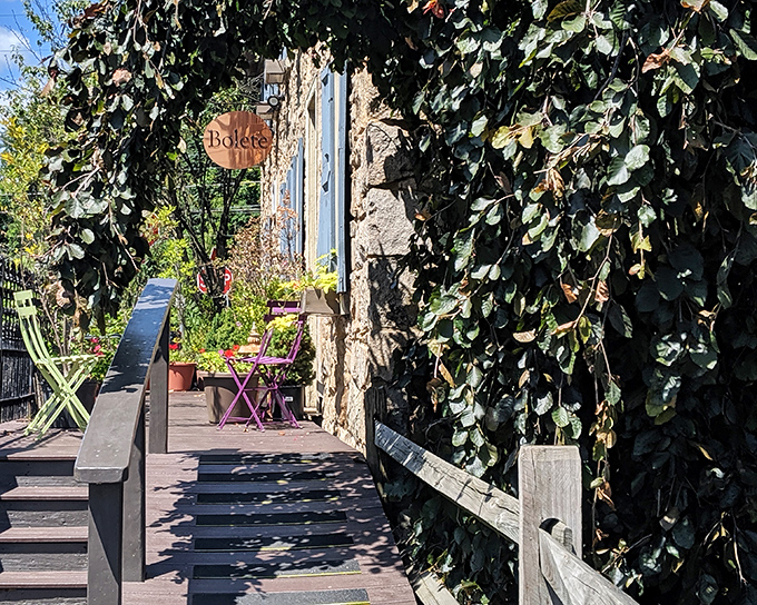 Nature embraces architecture at Bolete's entrance, where ivy-covered stone and a rustic wooden deck create the perfect prelude to the feast awaiting inside.