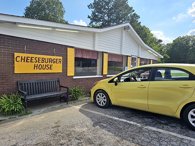 The unassuming exterior of Johnny's Cheeseburger House proves once again that culinary treasures often hide behind modest facades. Yellow shutters hint at the golden delights within.