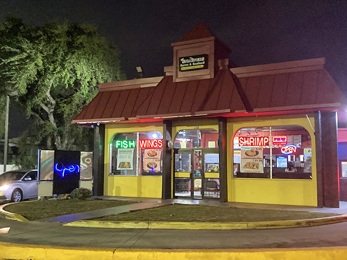 That yellow-and-red beacon of fried perfection glows like a lighthouse for hungry souls seeking seafood salvation.