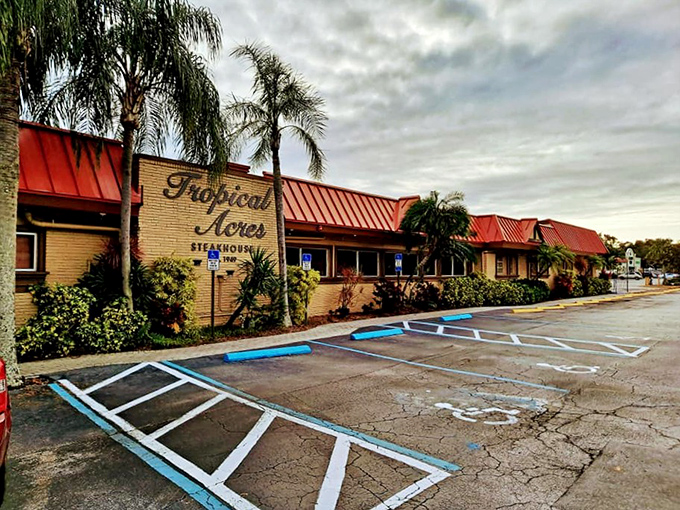 The iconic brick facade with "Tropical Acres" script has welcomed hungry Floridians since 1949. Some buildings age; this one seasons.
