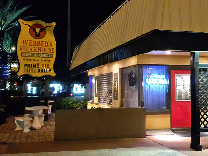 Webber's neon sign glows like a beacon in the night, promising carnivorous delights to weary travelers. The red door beckons like a portal to steak paradise.