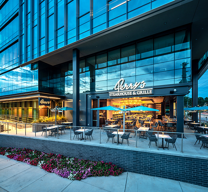 The gleaming glass facade of Perry's Steakhouse makes bank buildings jealous. Architectural swagger meets culinary promise in this modern meat embassy.
