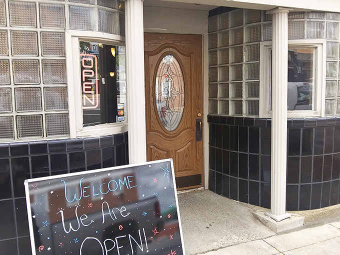 A handwritten "We Are OPEN!" sign welcomes you like an old friend's invitation. This unassuming entrance hides culinary treasures that would make even the most jaded foodie weak at the knees.
