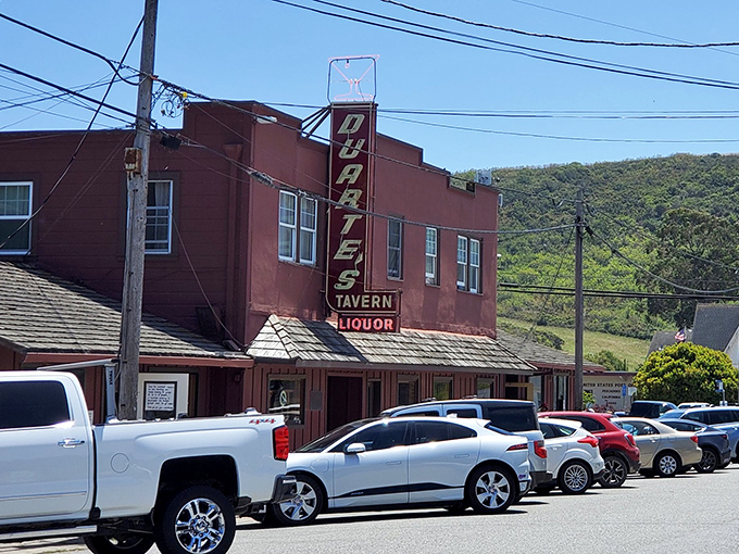 The iconic brick-red exterior of Duarte's Tavern stands proudly on Pescadero's main drag, its vintage neon sign beckoning hungry travelers like a coastal lighthouse.