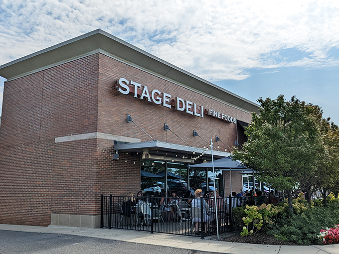 The brick exterior of Stage Deli stands proud in West Bloomfield Township, where locals queue up for what might be Michigan's most authentic deli experience.