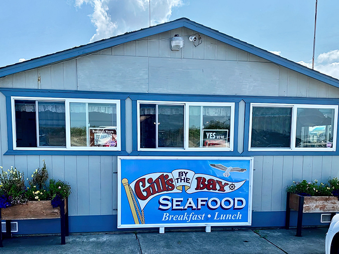 Bright blue trim frames this coastal hideaway like a picture postcard, complete with flower boxes that add a touch of homey charm to this seafood sanctuary.