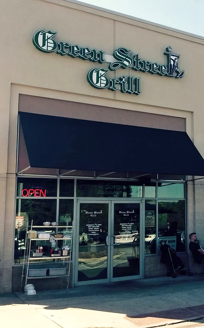 The unassuming exterior of Green Street Grill beckons with its classic green awning and glowing "OPEN" sign – a culinary treasure hiding in plain sight.