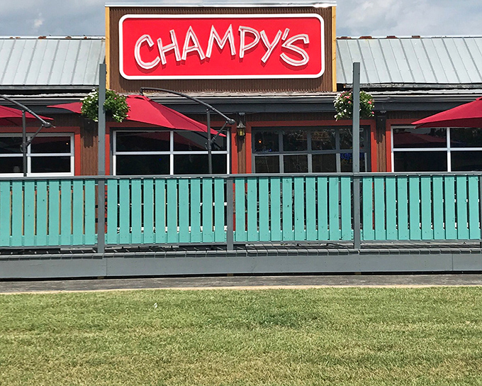 The bright red Champy's sign beckons like a lighthouse for the hungry, promising Southern comfort behind that cheerful turquoise fence.