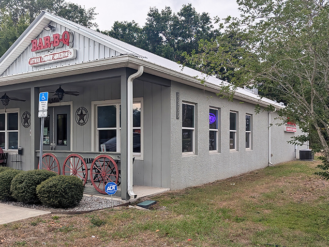 The unassuming exterior of Artman Country Smokehouse beckons with rustic charm. Those wagon wheels aren't just decoration&mdash;they're a promise of old-fashioned barbecue goodness waiting inside.