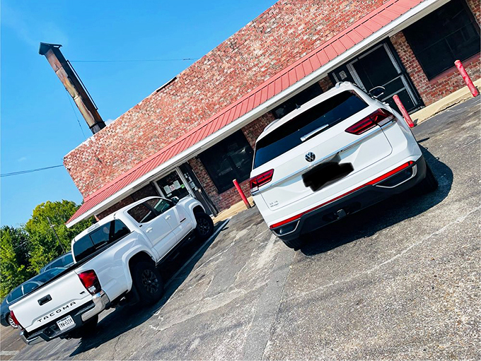 The unassuming brick exterior of E&L Barbeque&mdash;where culinary magic happens behind walls that have absorbed decades of heavenly smoke.