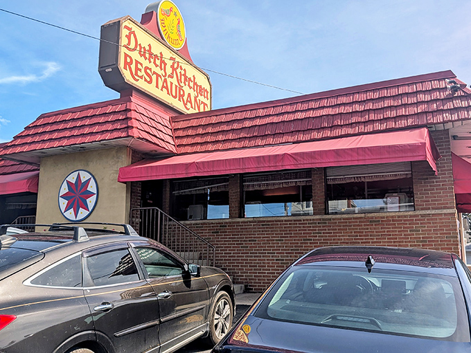 The iconic Dutch Kitchen sign beckons hungry travelers like a lighthouse for comfort food enthusiasts. That red roof practically screams "meatloaf inside!"