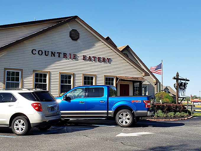 The Countrie Eatery stands proudly against a blue Delaware sky, its cream clapboard exterior promising comfort food treasures within.