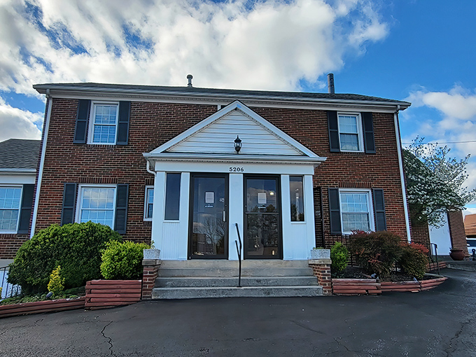 The stately brick exterior of Coach & Four stands like a culinary time capsule, promising old-school elegance before you even step through the door.