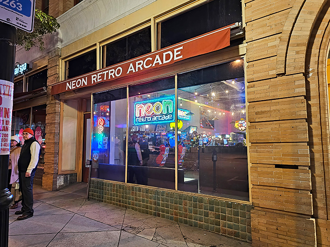 The neon glow beckons like a time portal on Pasadena's Raymond Avenue, promising digital adventures from decades past.