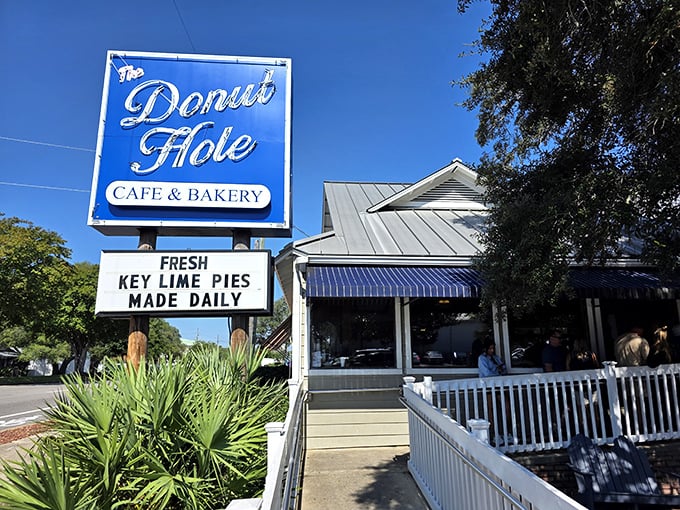 The iconic blue sign promises paradise in pastry form. Like a lighthouse for the hungry, it beckons with the magic words: "Fresh Key Lime Pies Made Daily."