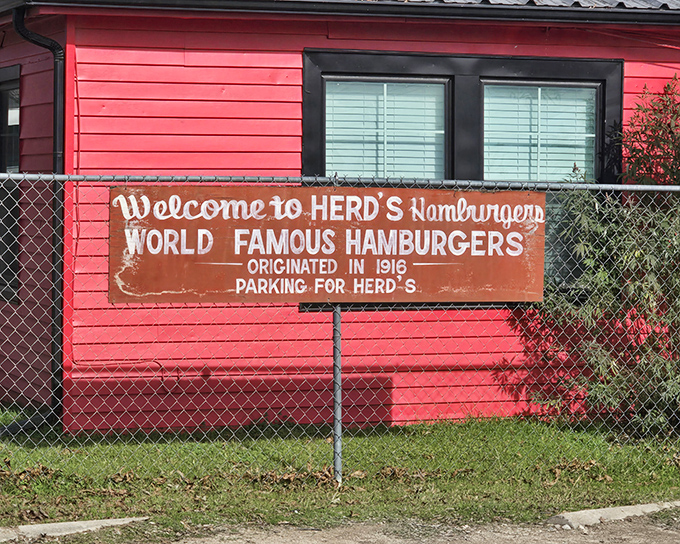 The iconic red exterior of Herd's Burgers stands as a beacon of burger perfection in Jacksboro, where that faded sign promises more than just a meal&mdash;it's a time machine to 1916.