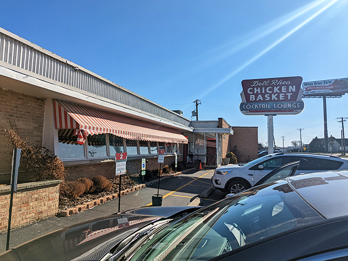 That vintage neon sign beckons like a beacon of fried chicken salvation along Route 66's legendary path.