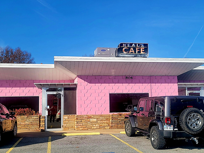 That iconic pink facade with the classic Neal's Cafe sign overhead&mdash;like a beacon calling hungry travelers home to Springdale's beloved dining institution.