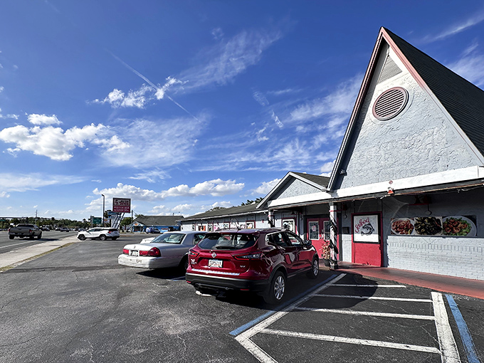 The iconic A-frame roof of Old Time Diner stands like a beacon of breakfast hope against the Florida sky, promising nostalgic flavors and zero pretension.