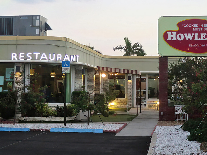 Mid-century modern meets Florida sunshine at Howley's, where the mint-green exterior promises a time-traveling culinary adventure that delivers on every level.