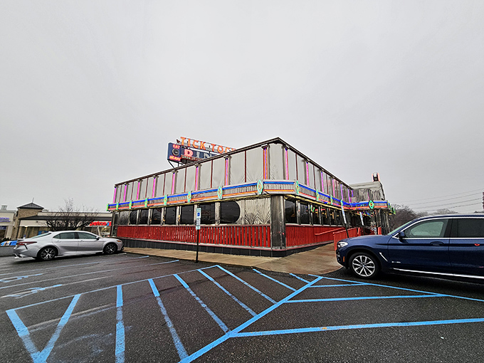 The gleaming chrome exterior of Tick Tock Diner stands like a time machine to a more delicious era, its neon sign promising culinary comfort 24/7.