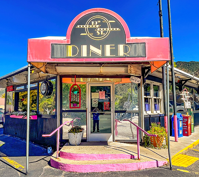 The pink-trimmed entrance of 19th Street Diner stands like a beacon of breakfast hope against New Mexico's blue sky. Resistance is futile.