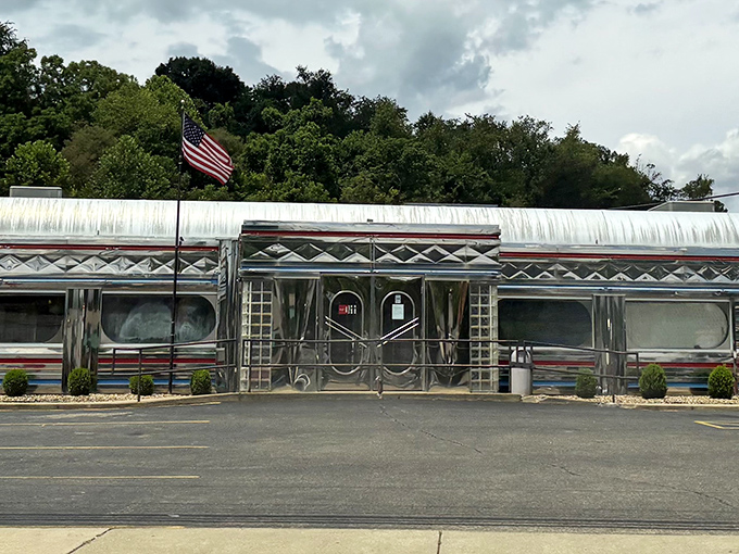 The gleaming stainless steel exterior of Diner 23 stands like a time machine on Route 23, complete with American flag proudly waving above this chrome-plated temple of comfort food.