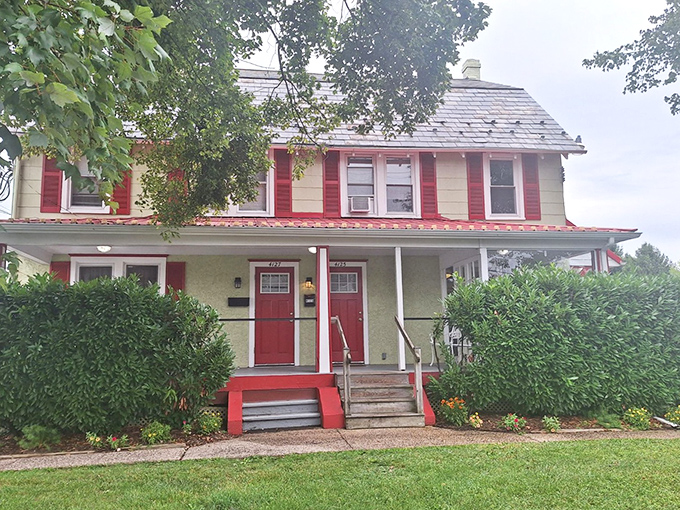 The Cross Keys Diner's charming farmhouse exterior, with its crisp white siding and cherry-red trim, promises comfort before you even step inside.
