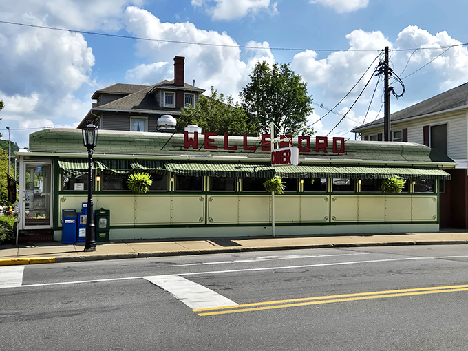 The classic green and cream exterior of Wellsboro Diner stands proudly on Main Street, a time capsule of Americana waiting to feed hungry souls.